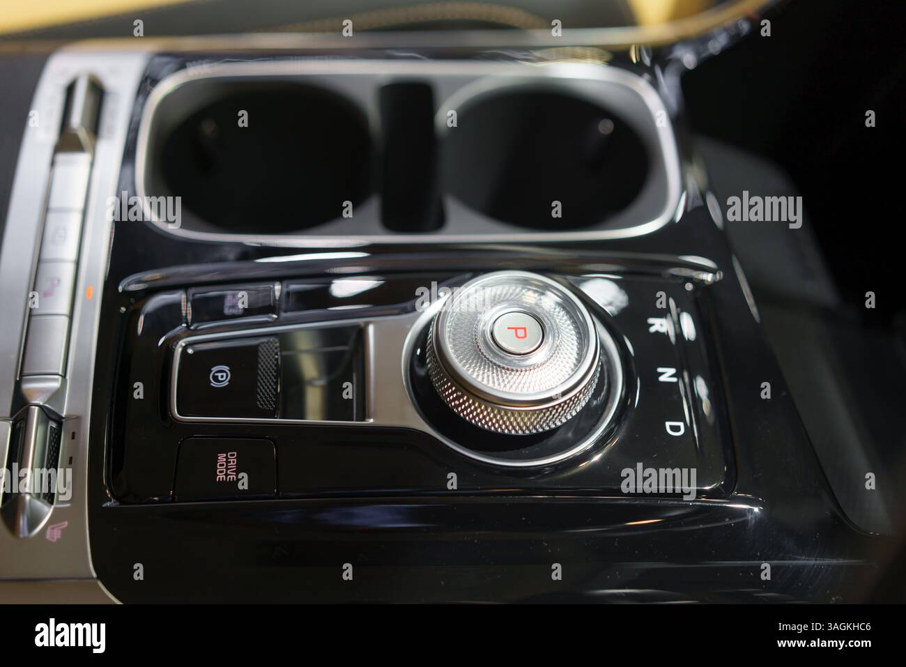 detailed view of a sleek automotive center console featuring a rotary ...