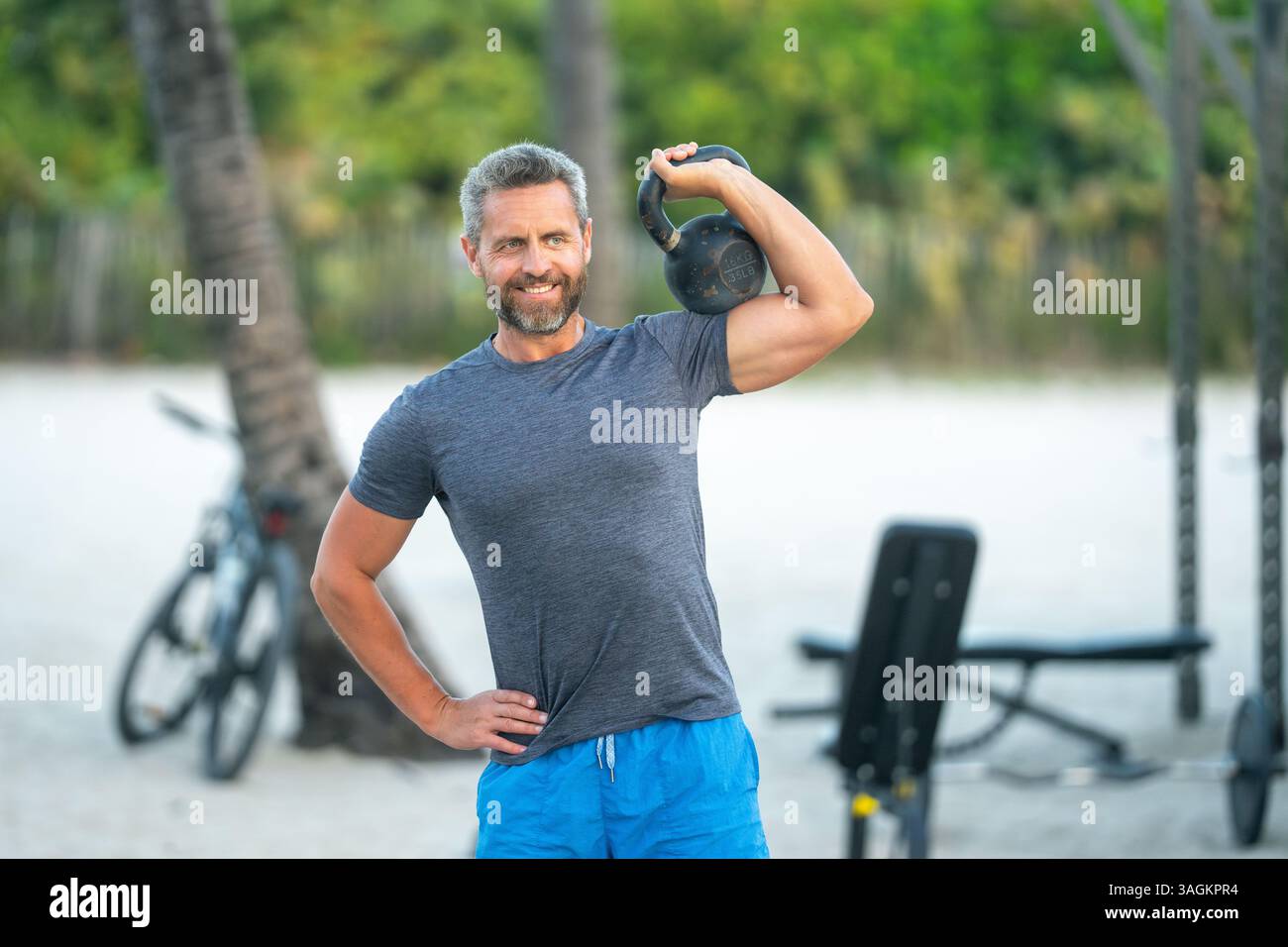 Outdoor fitness training. Sporty and muscular male working out. Beach ...