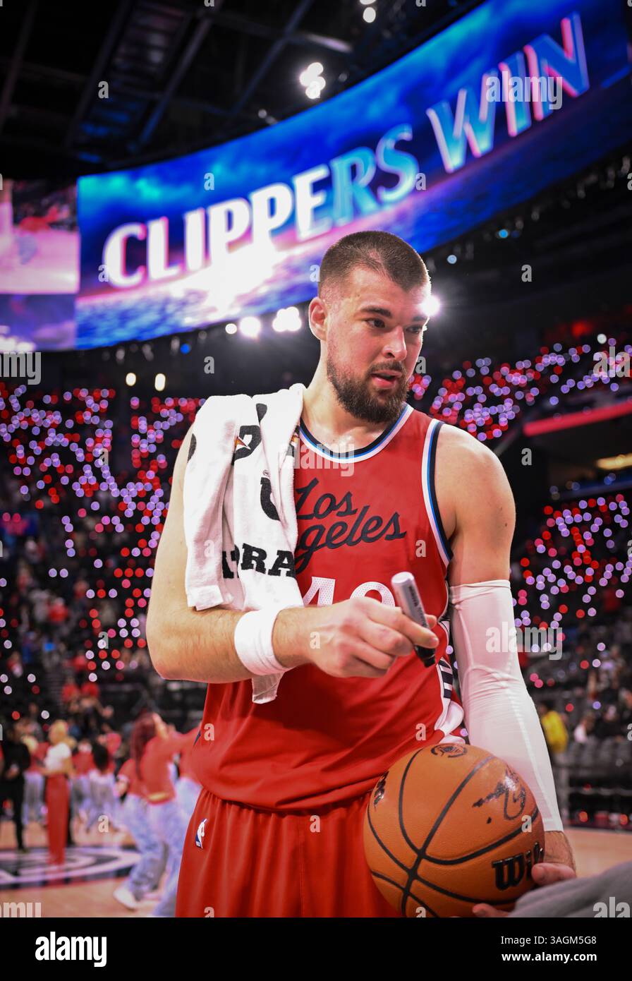 Los Angeles Clippers center Ivica Zubac (40) signs a ball after an NBA ...