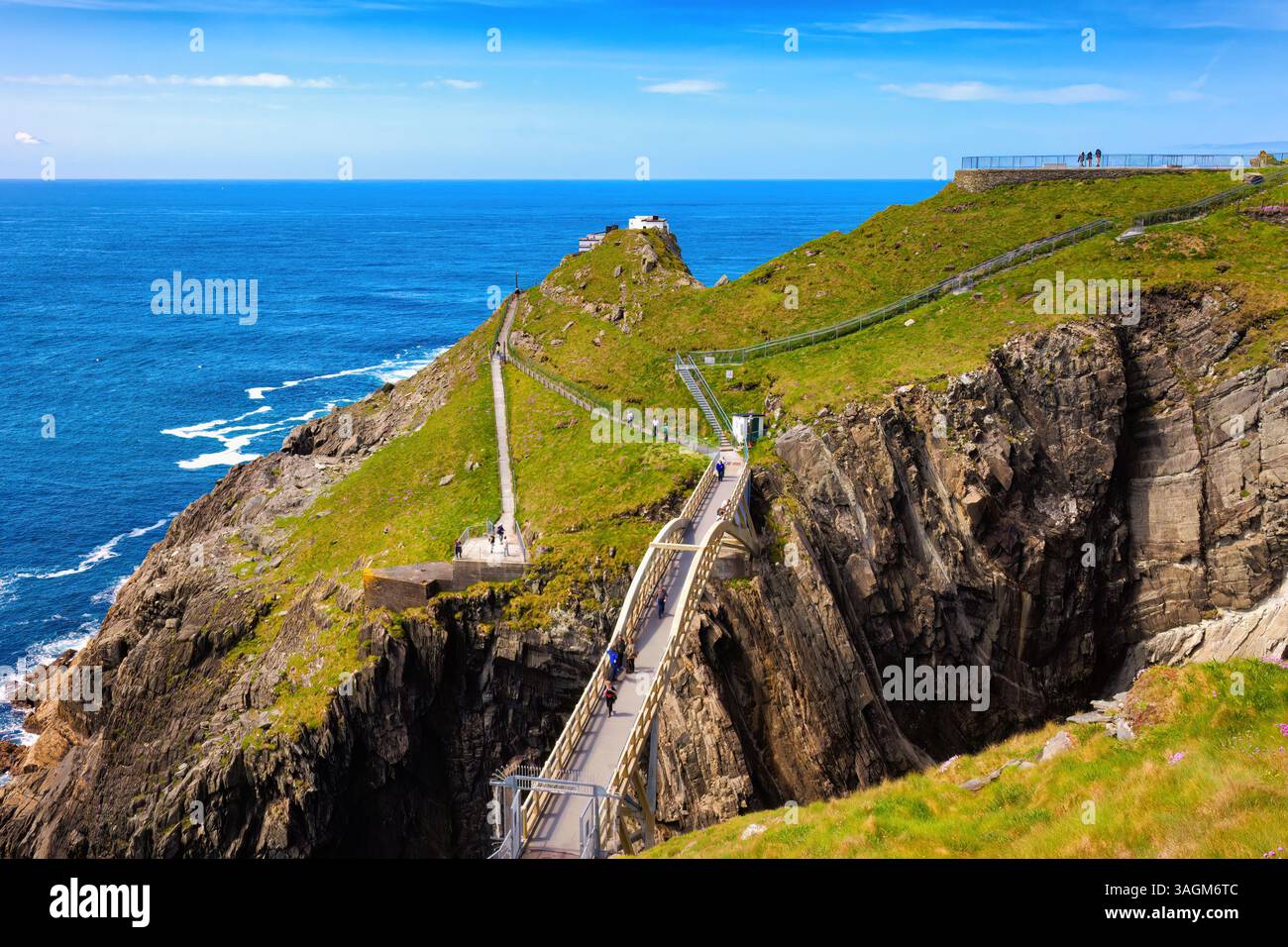 Iconic arched bridge connecting cliffs at Mizen Head, Ireland. Green ...