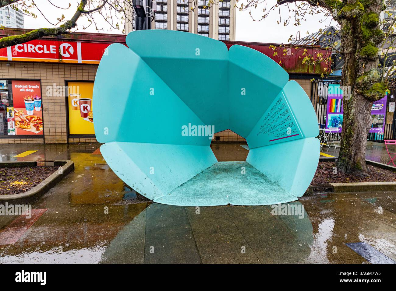 A blue geometric Pop-Up Pavilion in a rain-soaked urban space at Jim ...