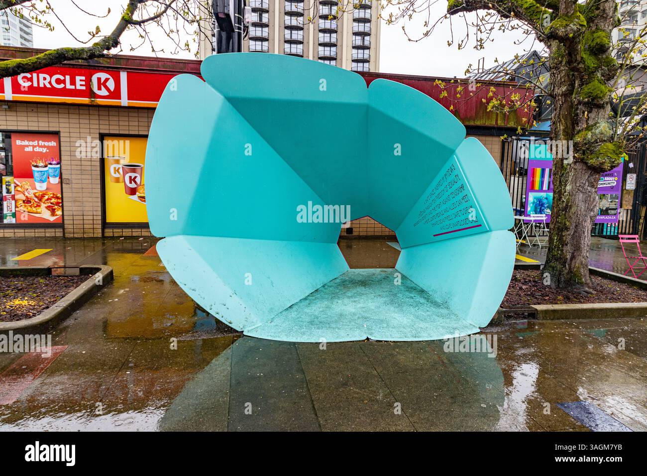 A blue geometric Pop-Up Pavilion in a rain-soaked urban space at Jim ...
