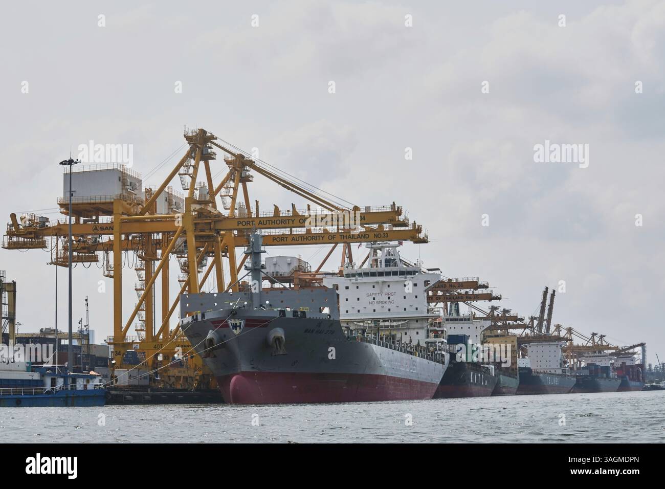 Cranes work on stacks of containers at Bangkok Port in Bangkok ...