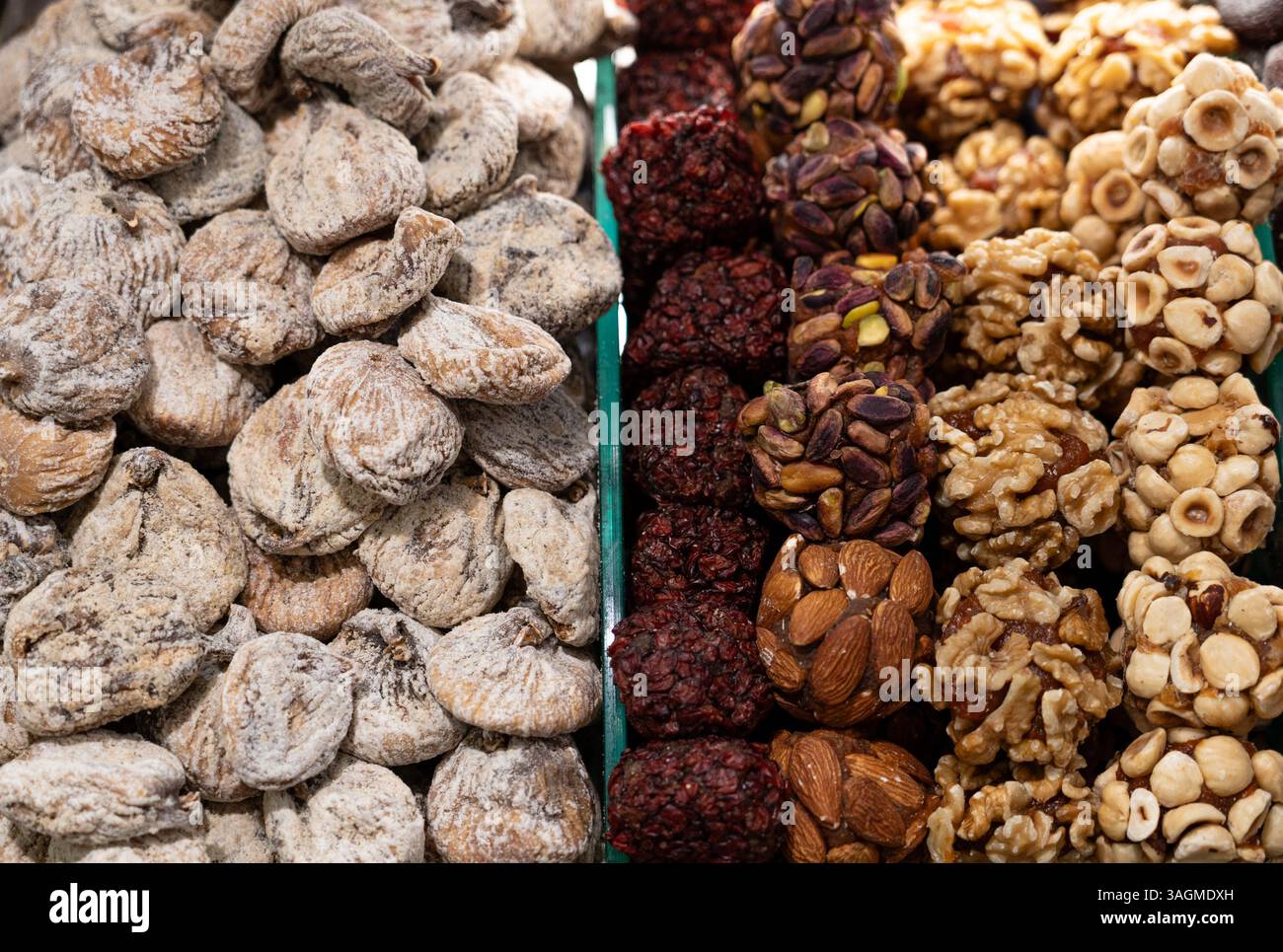 Healthy snack display with dried figs, nut-covered fruit balls and ...