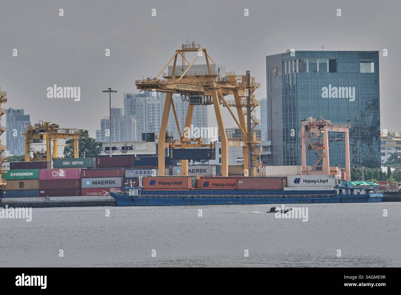 Cranes work on stacks of containers at Bangkok Port in Bangkok ...