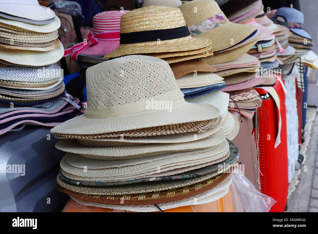 A row of summer hats arranged in different colors and styles displayed ...