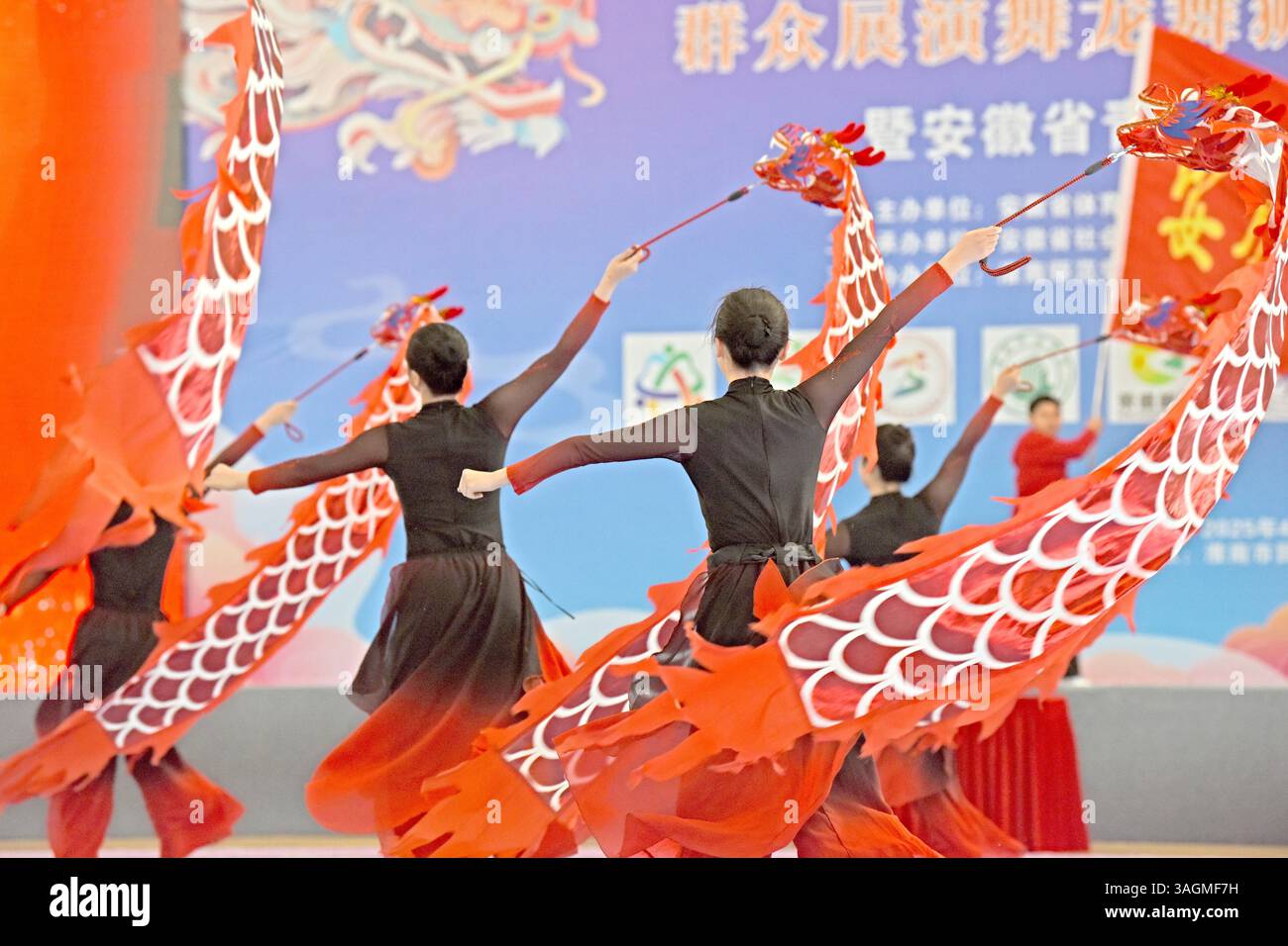 People perform at a ribbon dragon dance competition in Huainan City ...