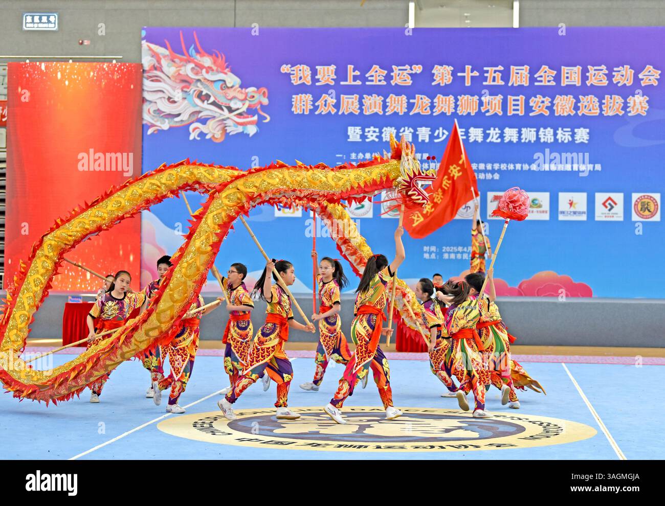 People perform at a ribbon dragon dance competition in Huainan City ...