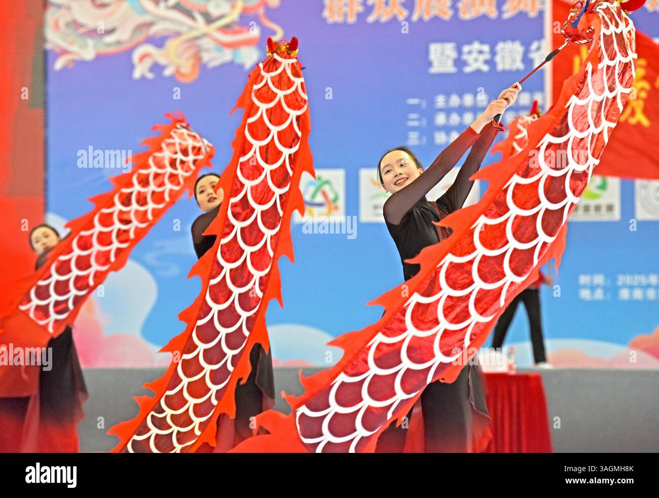 People perform at a ribbon dragon dance competition in Huainan City ...