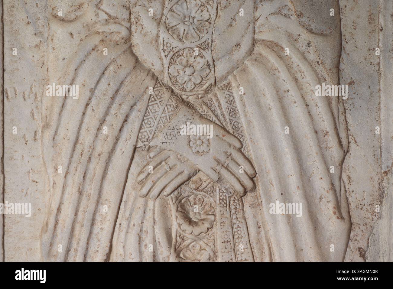 White stone tablet detail with sculoted hands and garments at the St ...