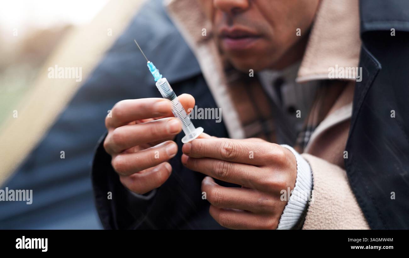Hands, poverty and homeless with needle, drugs and tent with addiction ...
