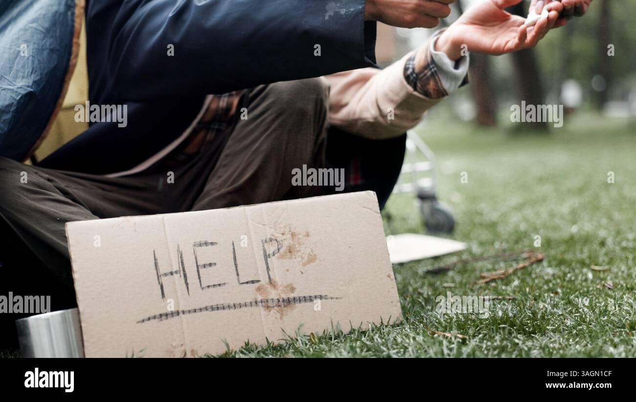 Hands, homeless and poverty with sign, drugs or deal for begging money ...