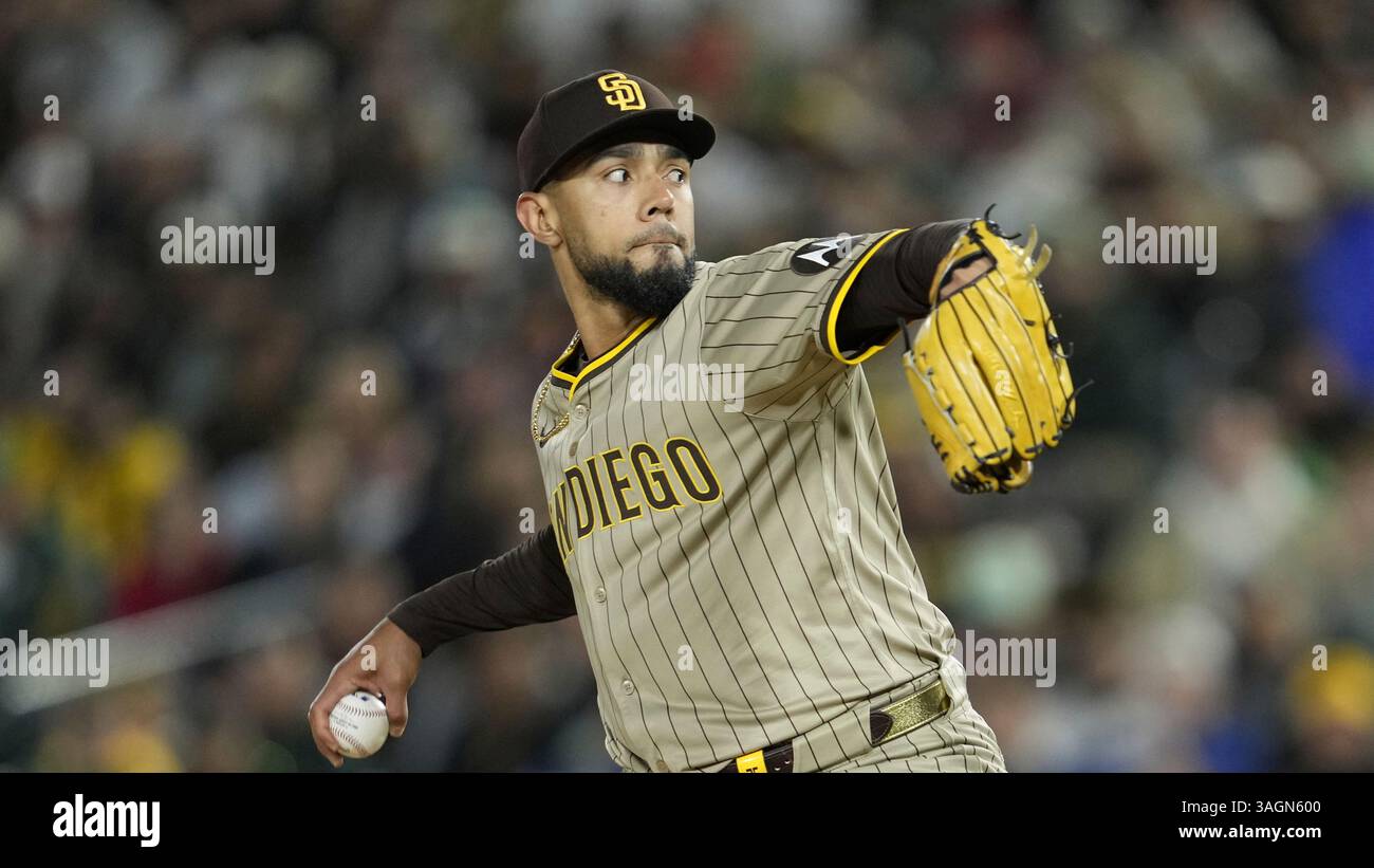 San Diego Padres pitcher Robert Suarez throws to an Athletics batter during a baseball game ...