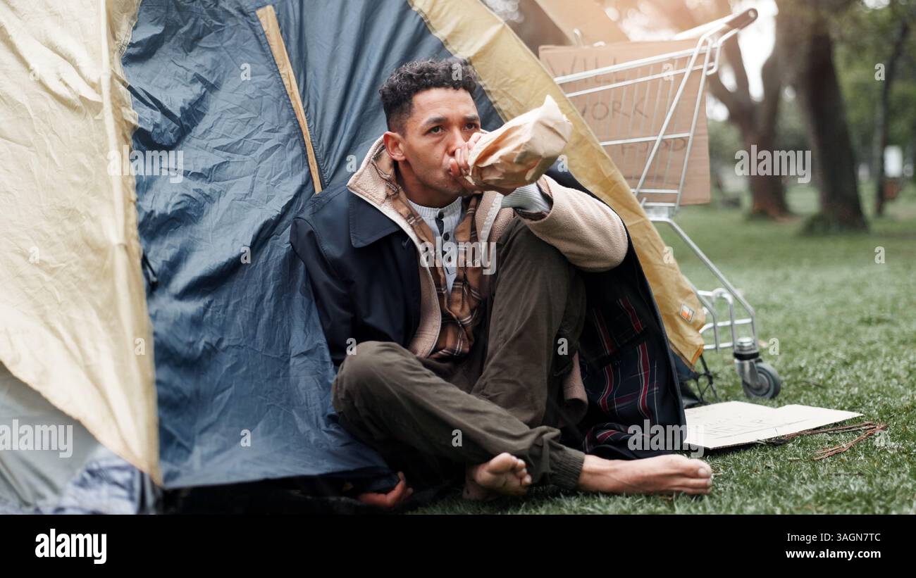 Man, poverty and outdoor with alcohol, drink and tent with addiction ...