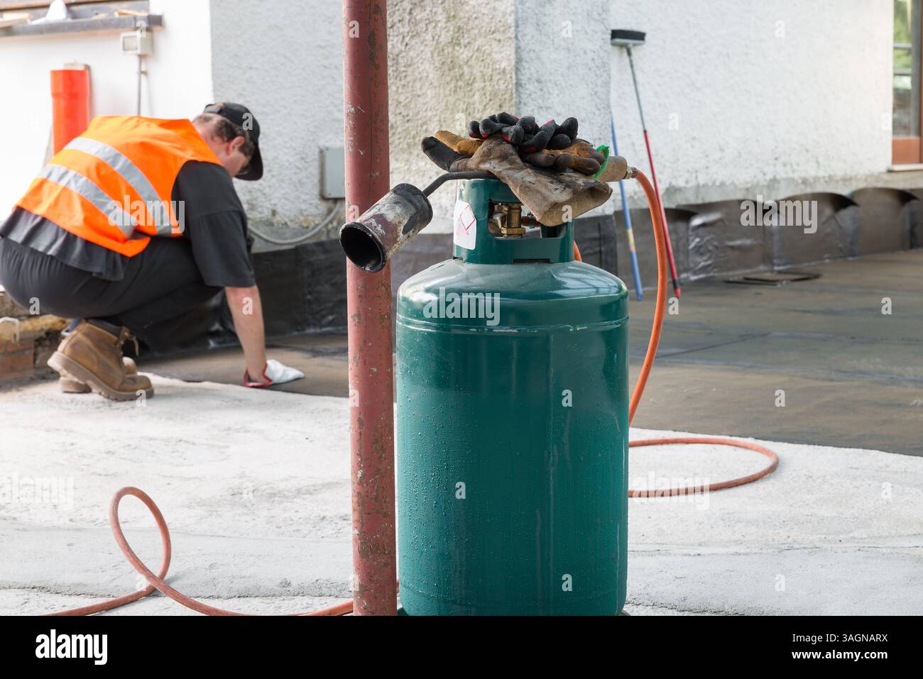 Waterproofing of a terrace - roof of a home with rolls of bituminous waterproofing membrane ...