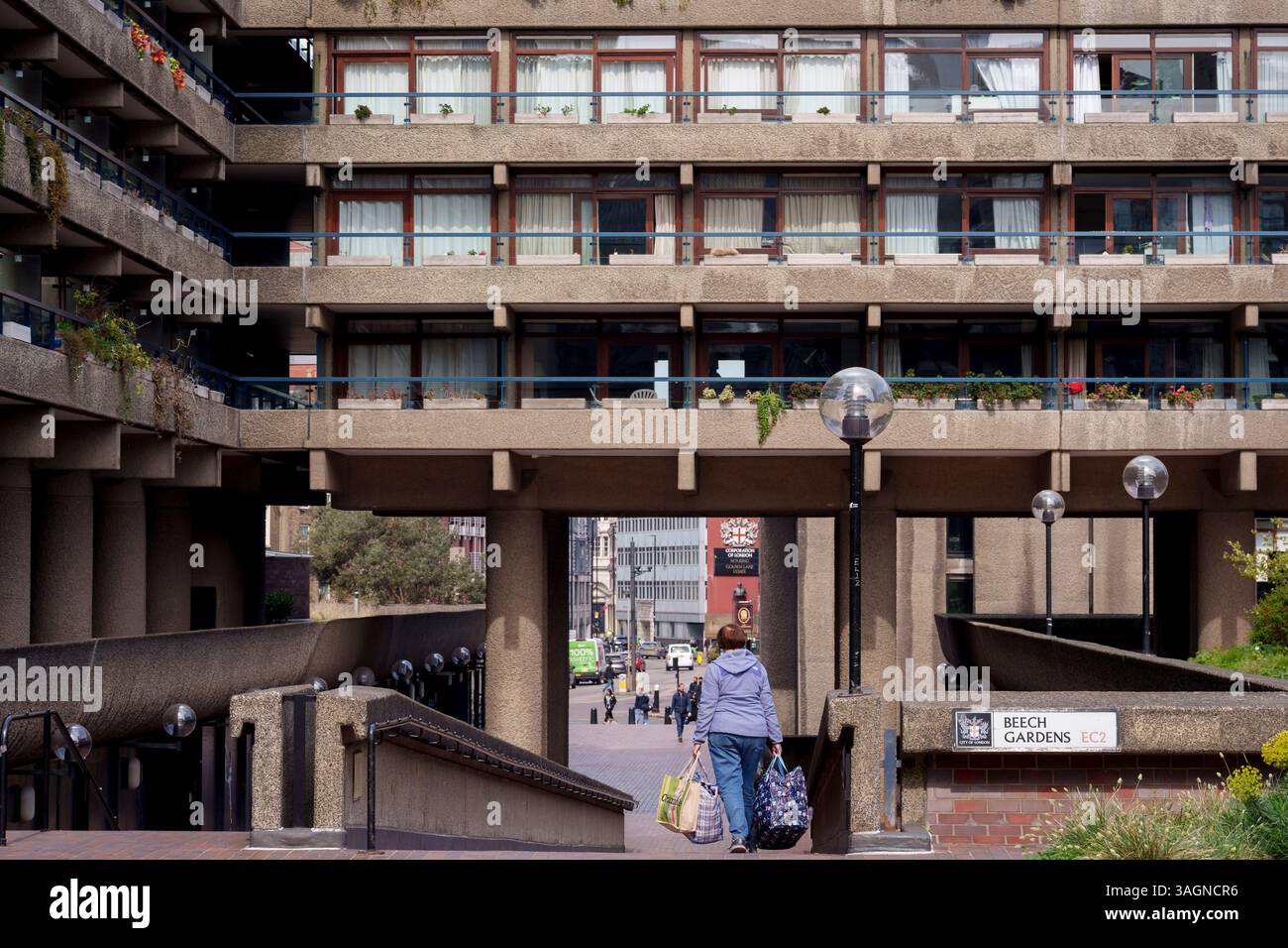 A walkway, residential flats and brutalist-style concrete architecture ...