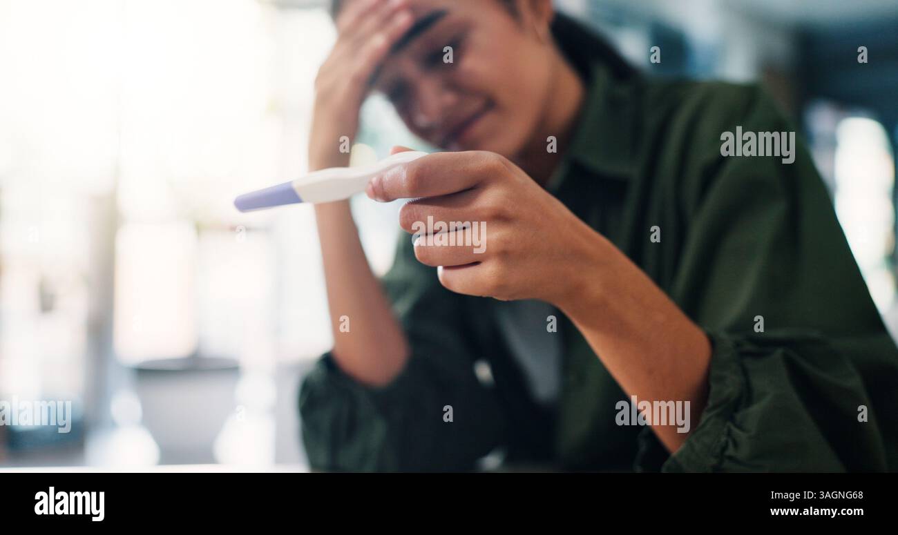 Home, sad and woman with pregnancy test, stress and overwhelmed with ...