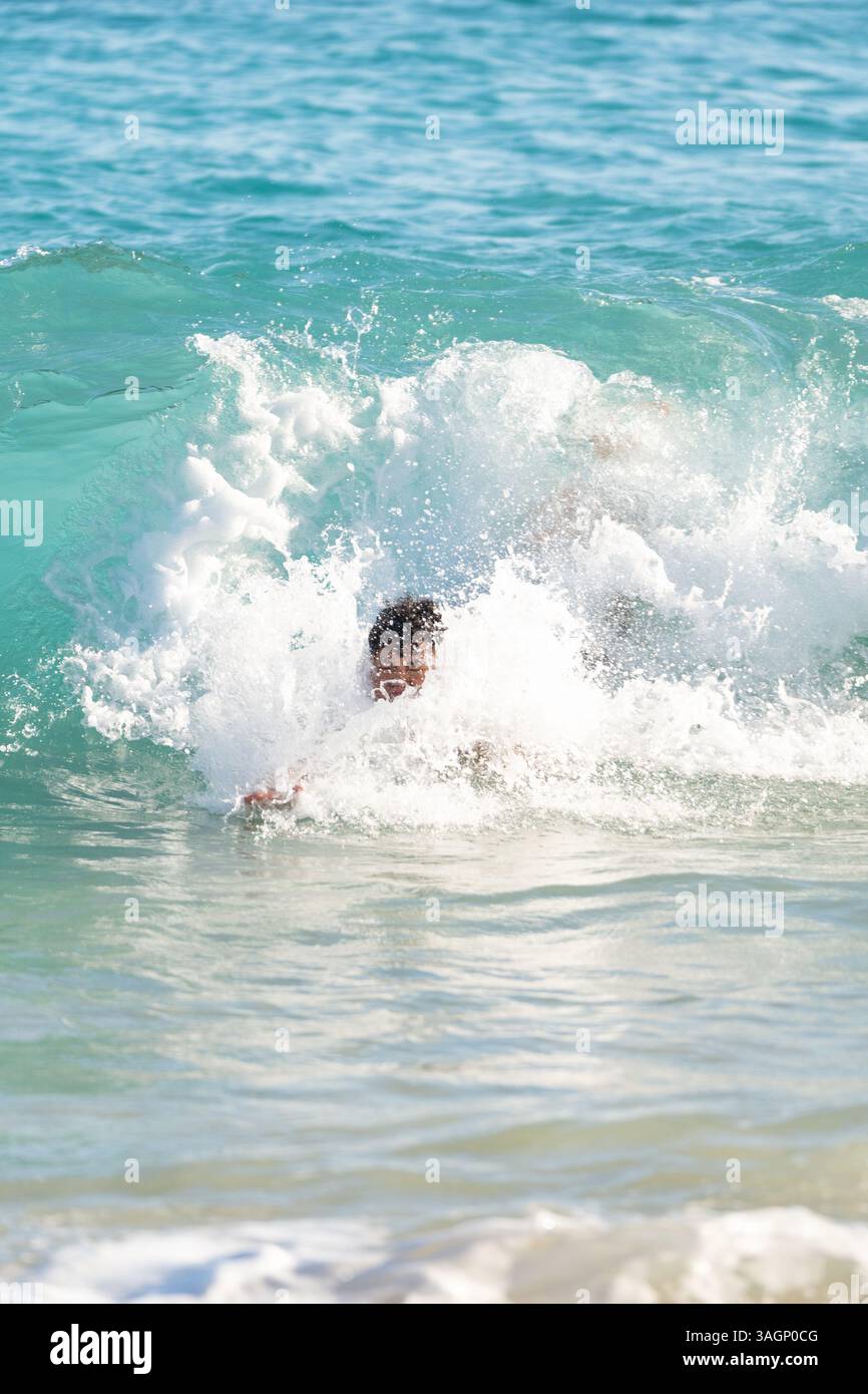 Body Surfer rides tropical wave at sunny beach, capturing summer fun ...