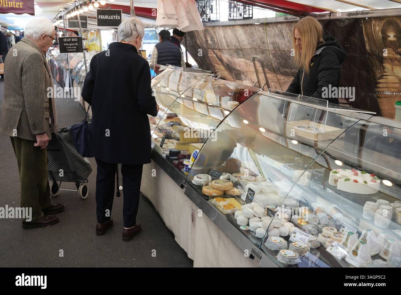 People buy cheese at an open air market as President Donald Trump's ...