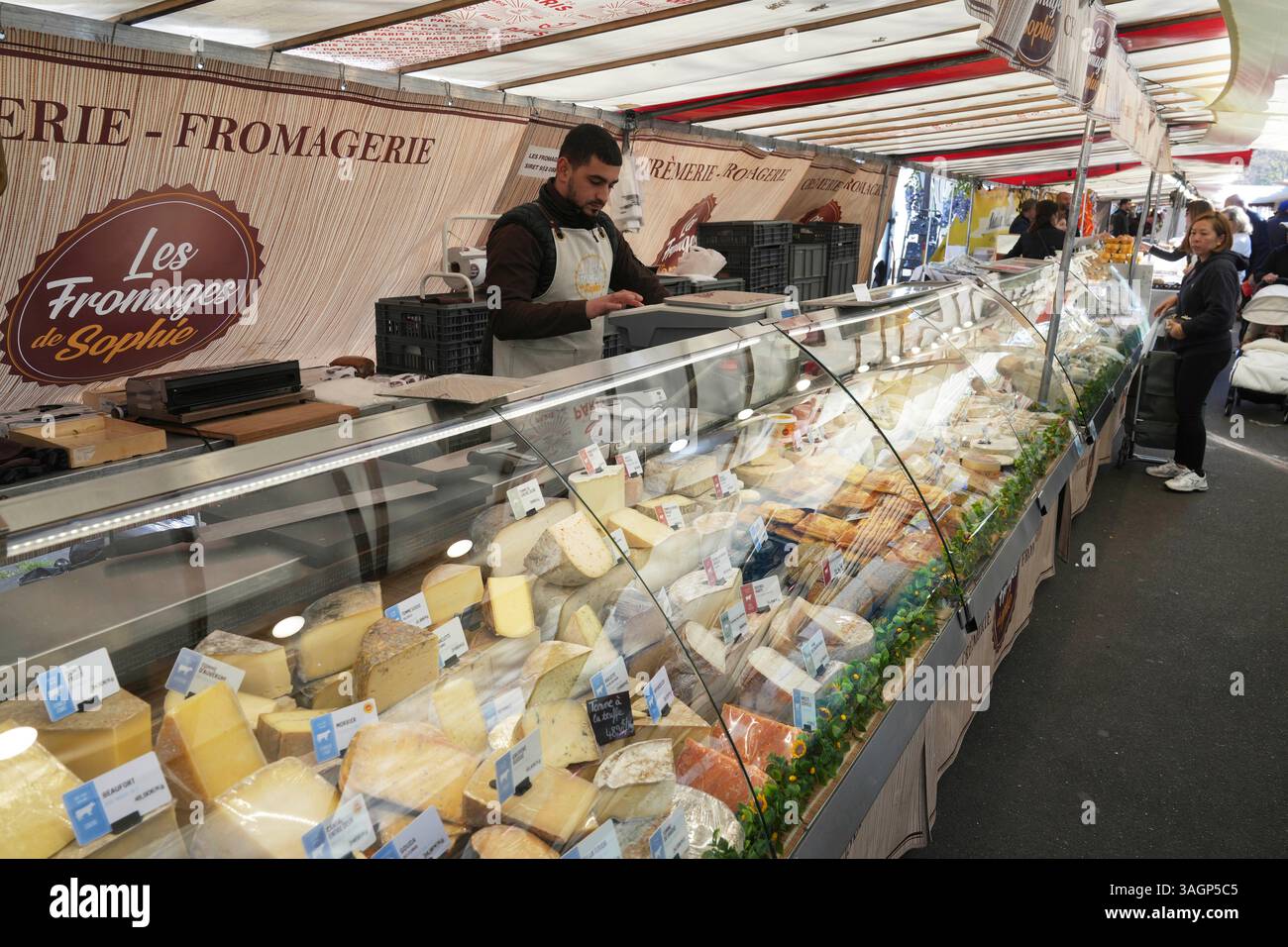 A man sells cheeses at an open air market as President Donald Trump's ...