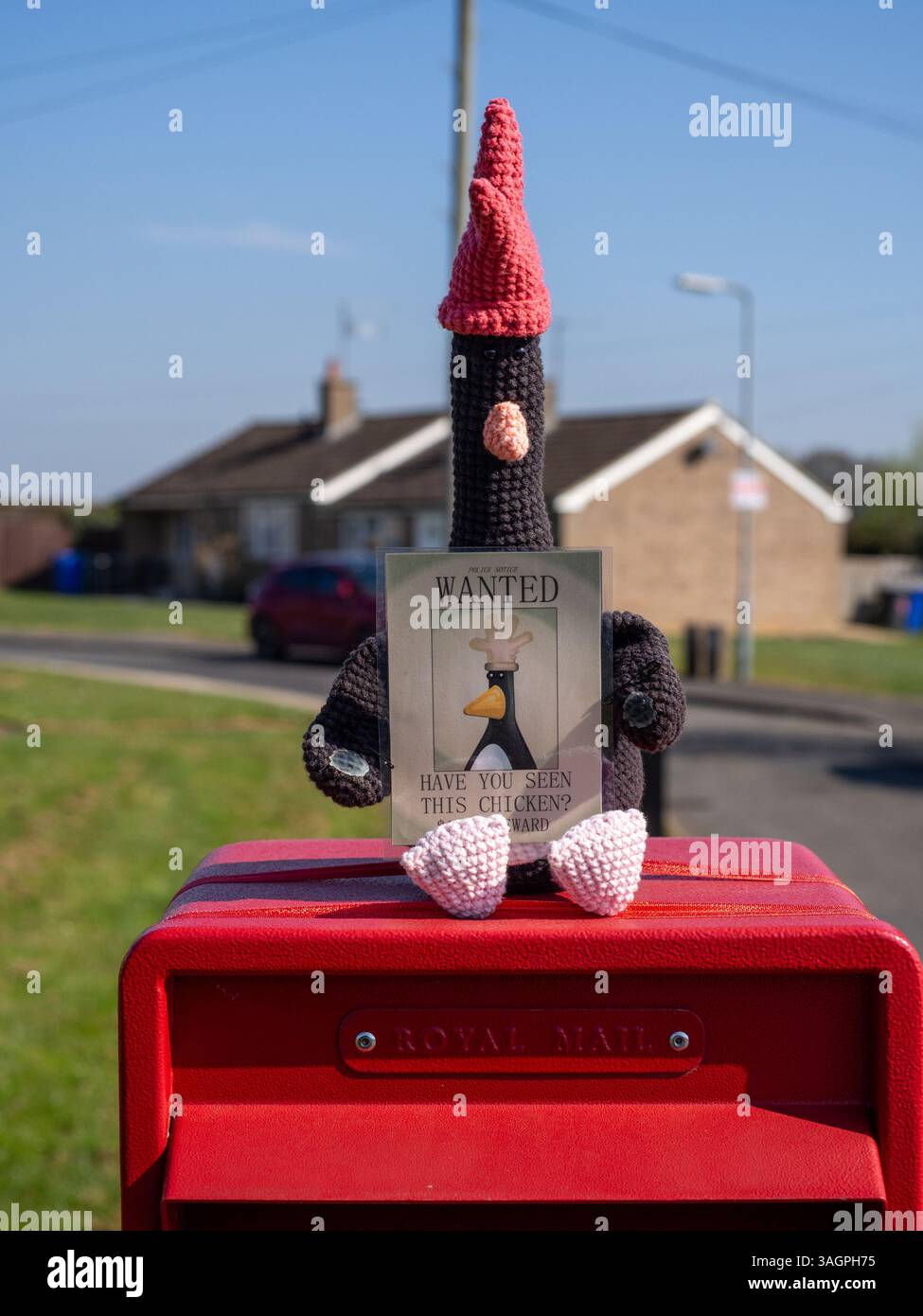 Royal Mail post box with a knitted topper of Feathers McGraw, the ...