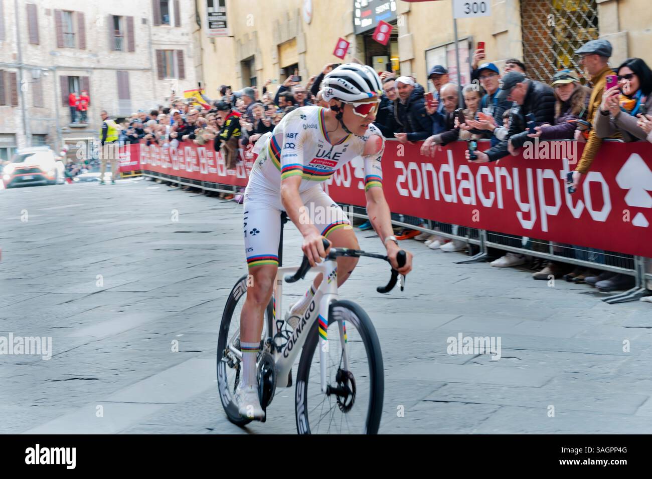 Tadej pogacar cycling to victory in the strade bianche 2025, cheered by enthusiastic fans, Siena ...