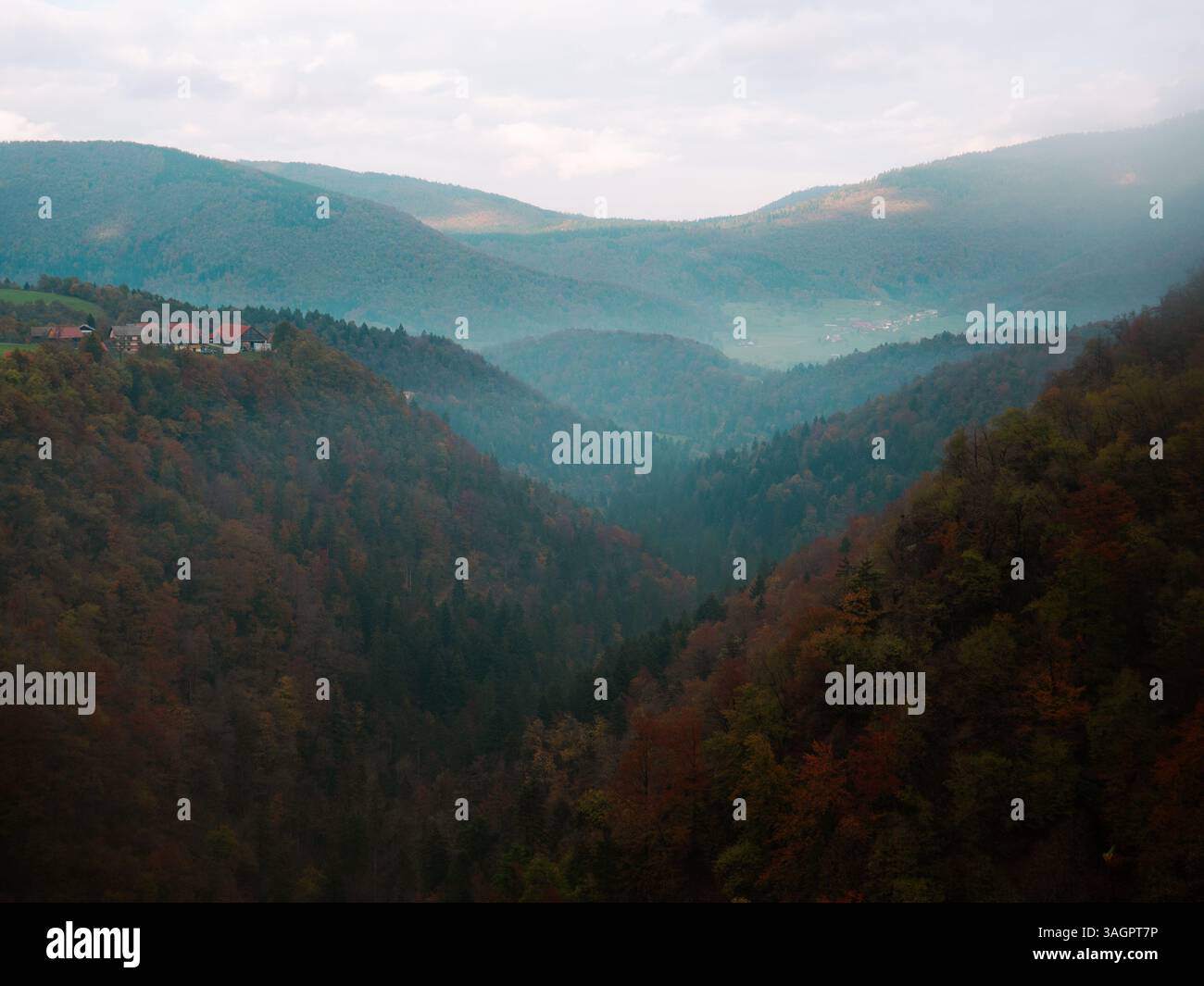 Scenic View of Forested Mountains with Small Villages Under a Cloudy ...