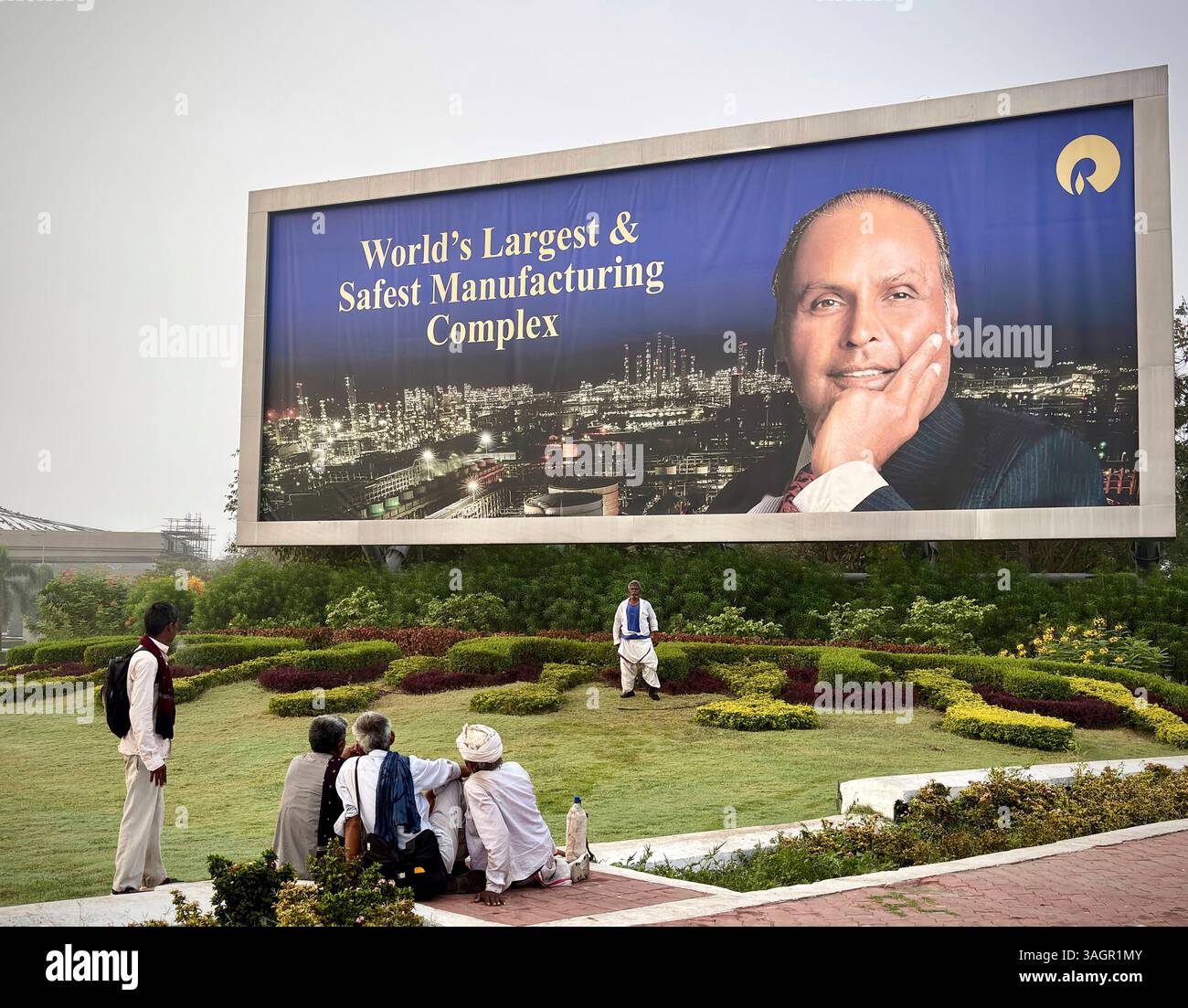 Villagers sit in the lawns outside the Jamnagar Refinery run by the Indian business conglomerate ...