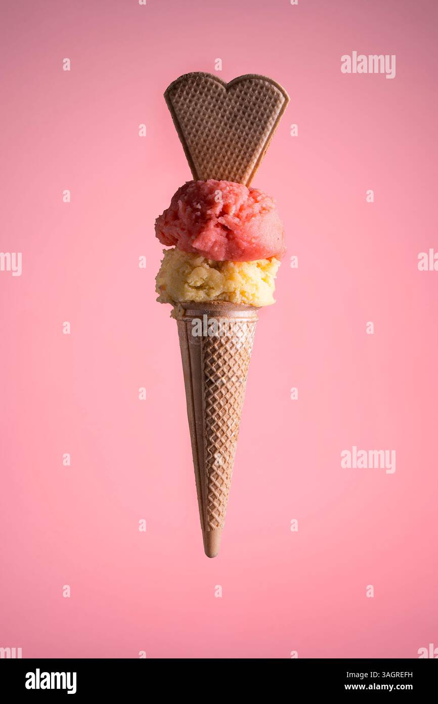 Colorful gelato cone with strawberry and almond flavors topped with a ...