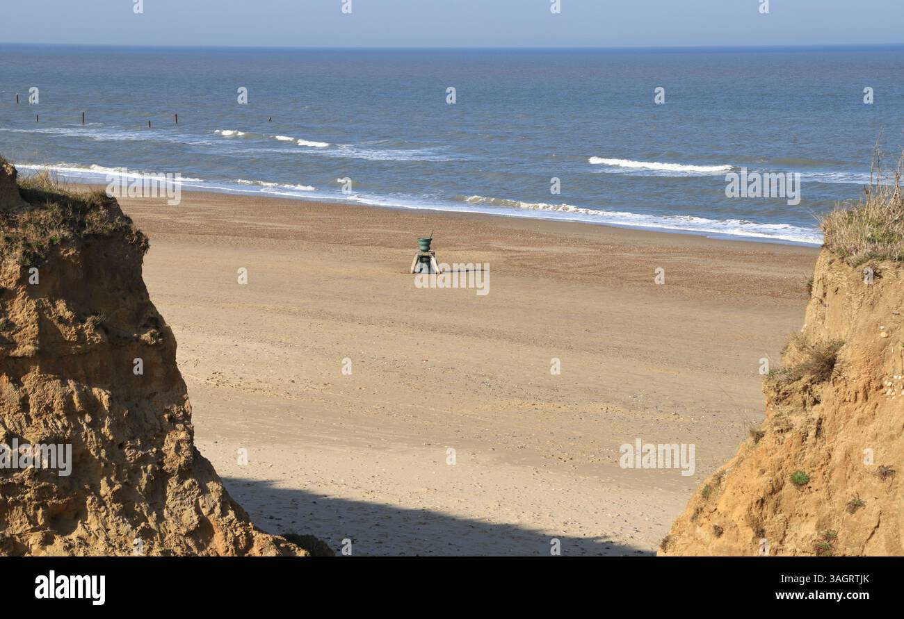 A view of the beach and sea at low water with The Spirit of Happisburgh ...