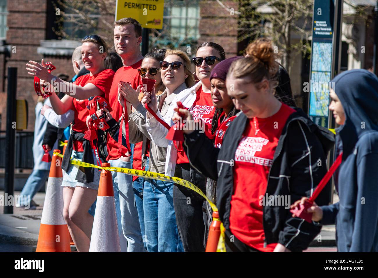 People supporting and cheering the runners in the street during the ...