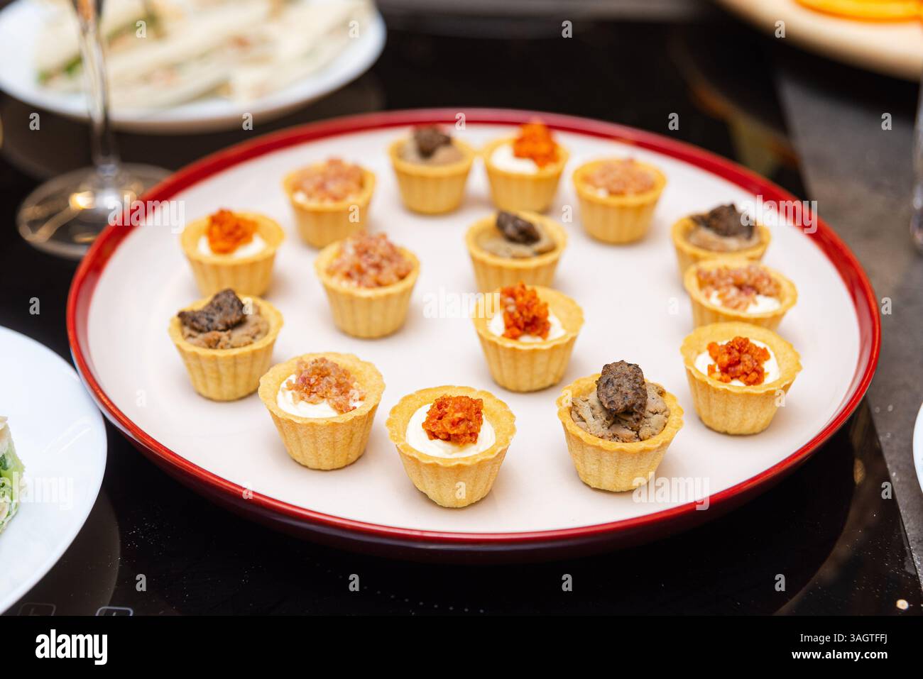 Assorted mini tartlets filled with creamy spreads and savory toppings ...