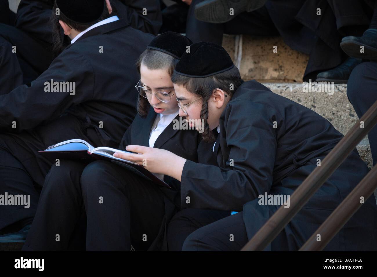 During recess at a yeshiva, 2 orthodox Jewish student studies together ...
