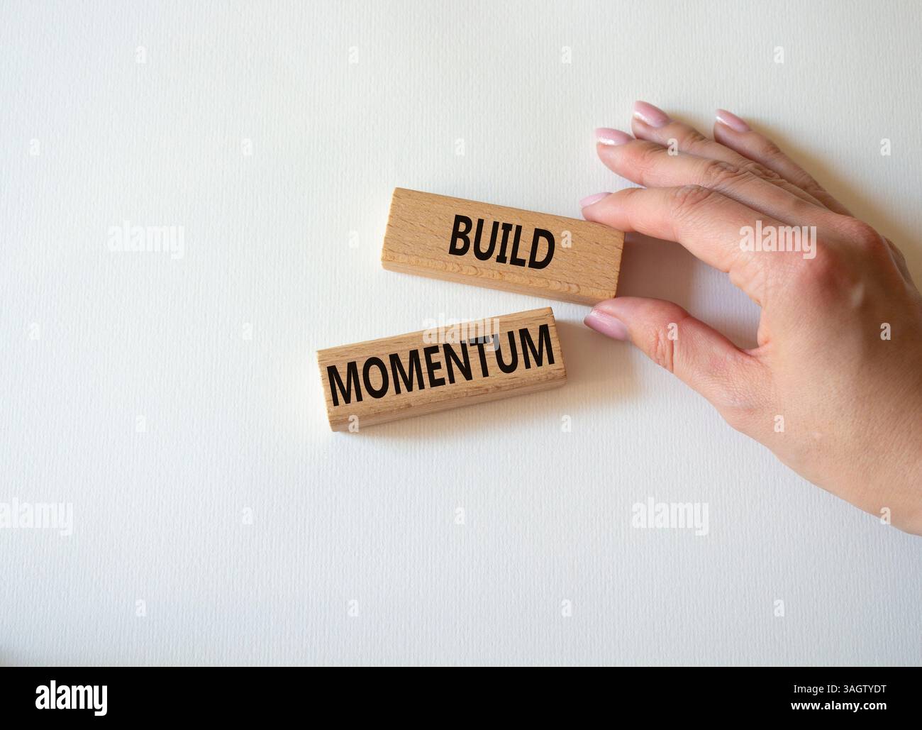 Build momentum symbol. Wooden blocks with words Build momentum ...