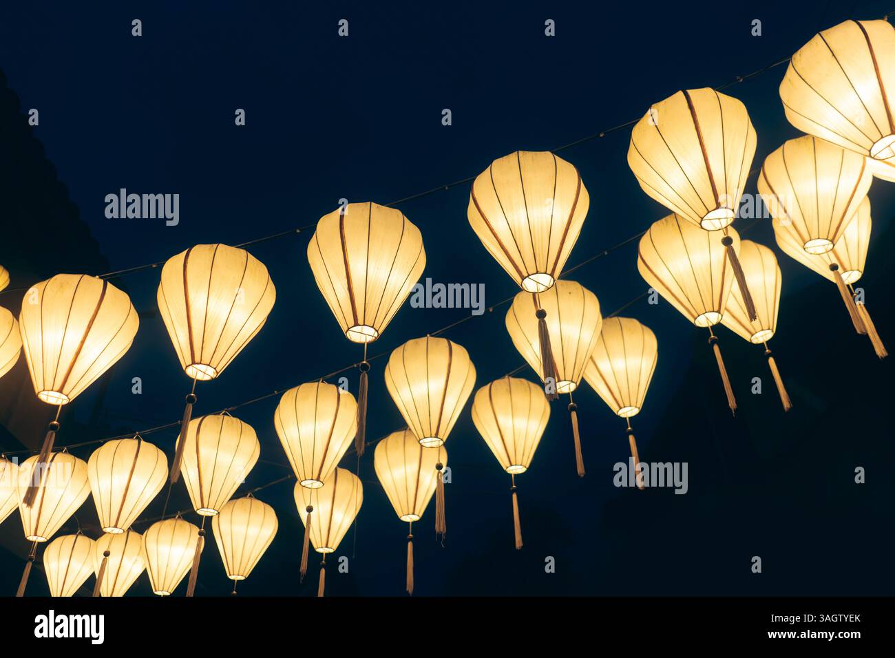 Traditional Asian lanterns glow with warm light creating festive magic ...