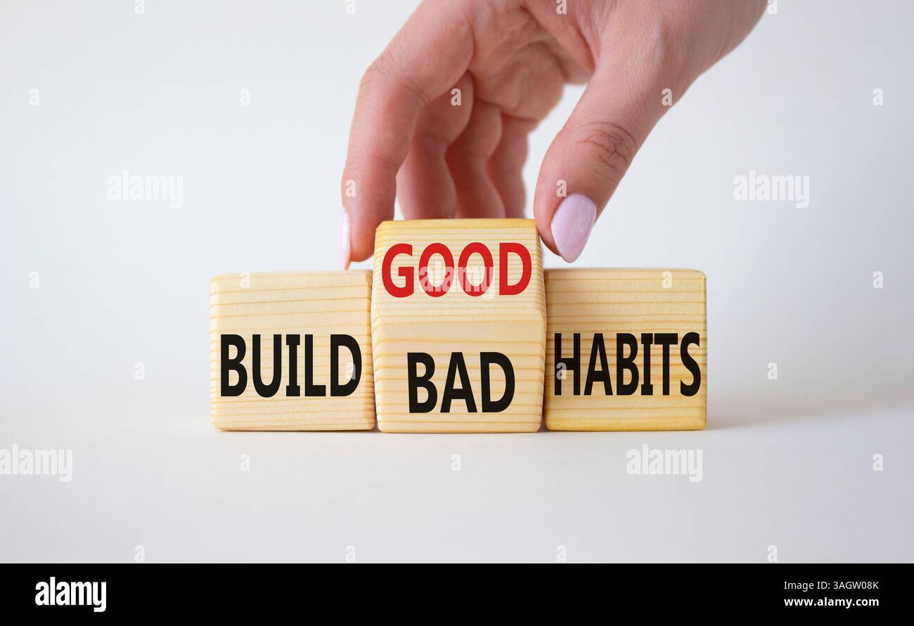 Build Good or Bad Habits symbol. Businessman hand turns wooden cubes ...