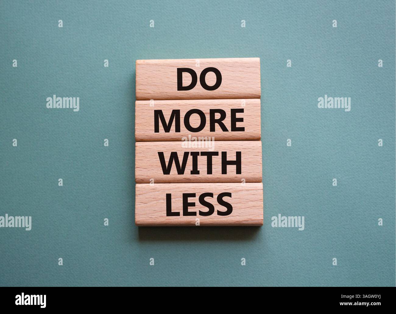 Do more with less symbol. Concept words Do more with less on wooden ...