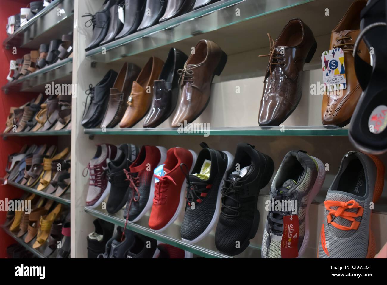 A vibrant collection of shoes is arranged neatly on shelves in a retail ...