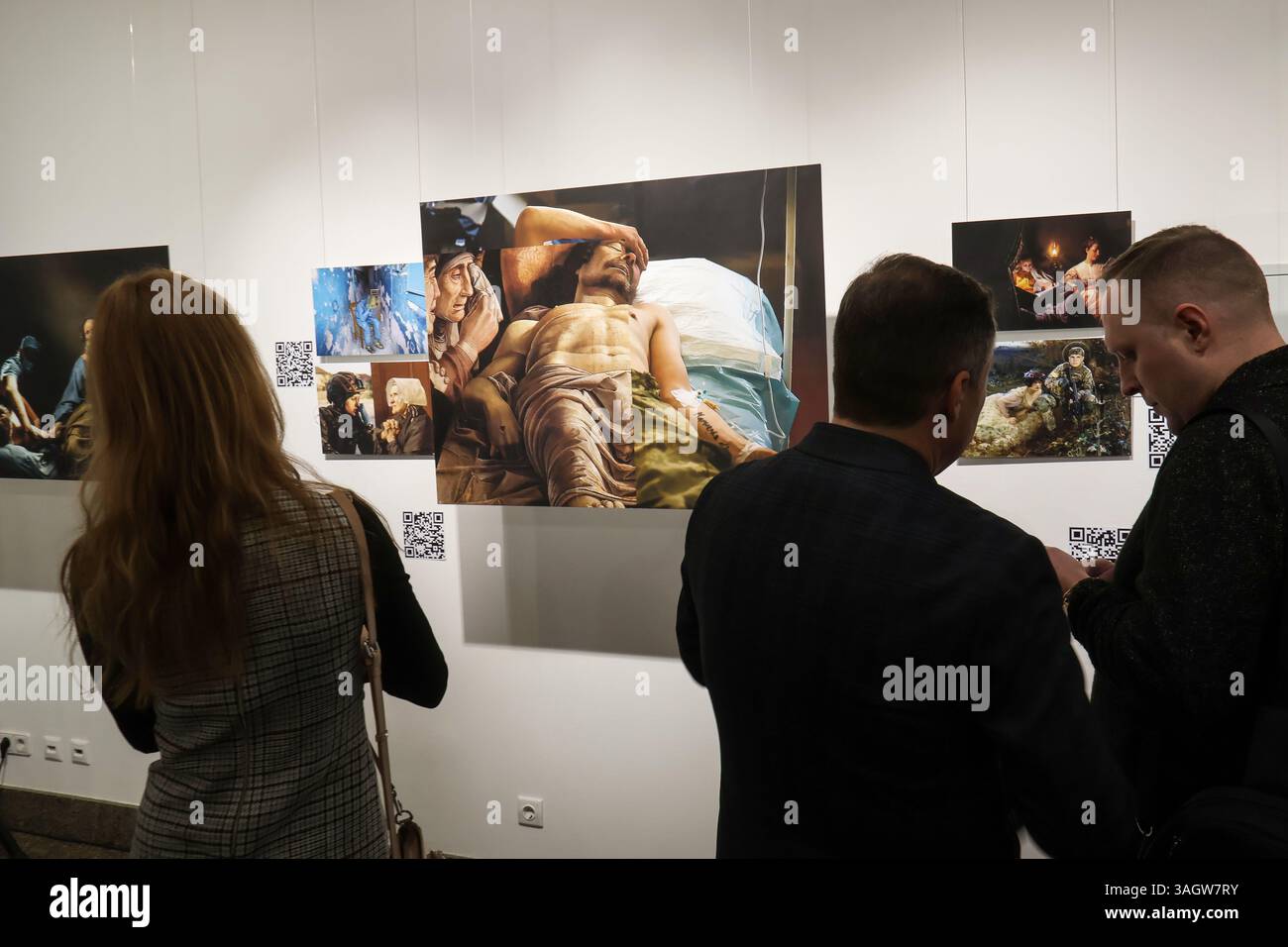 Visitors look at showpieces at the opening of the “In Memoriam. Reality Through Art” exhibition ...