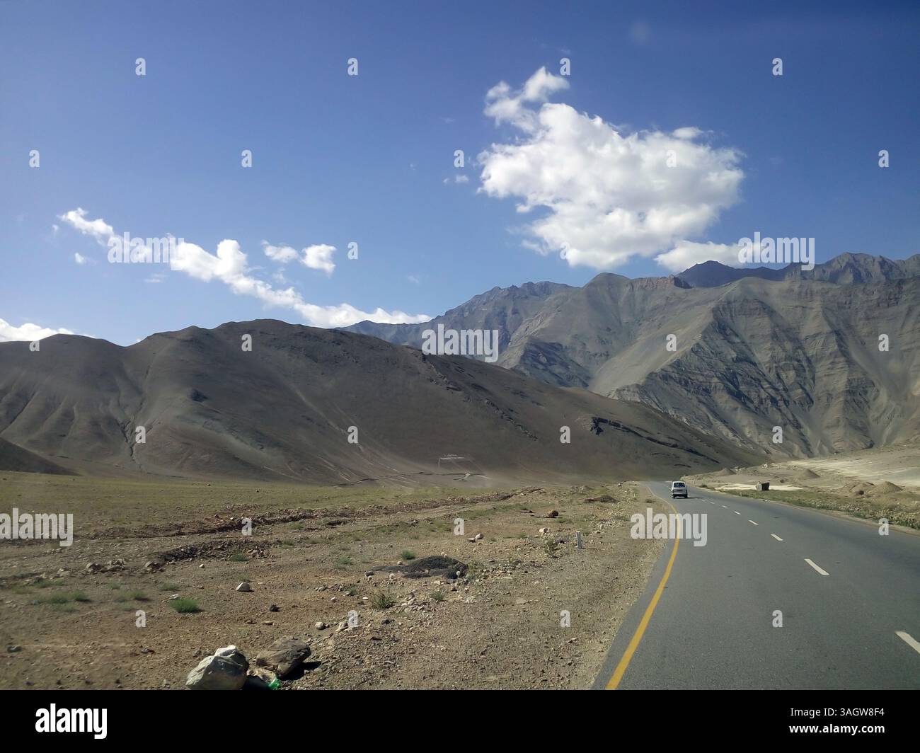 Winding road cuts through the impressive rocky formations of Leh Ladakh ...