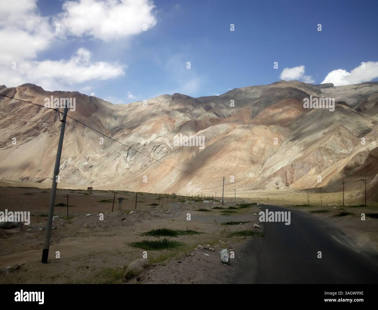 Winding road cuts through the impressive rocky formations of Leh Ladakh ...