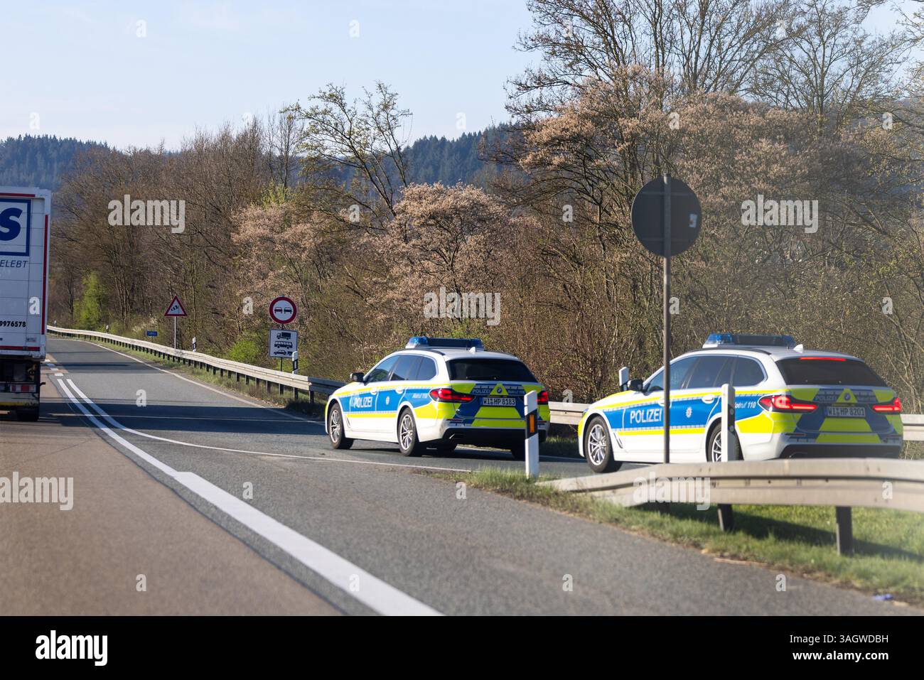 09 April 2025, Hesse, Ehringshausen/Herborn: Police tow trucks wait in ...