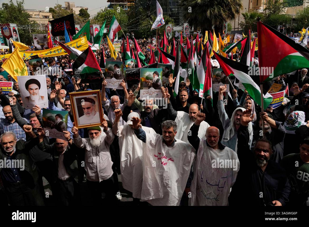 Iranian protesters chant slogans as they hold Palestinian flags while ...