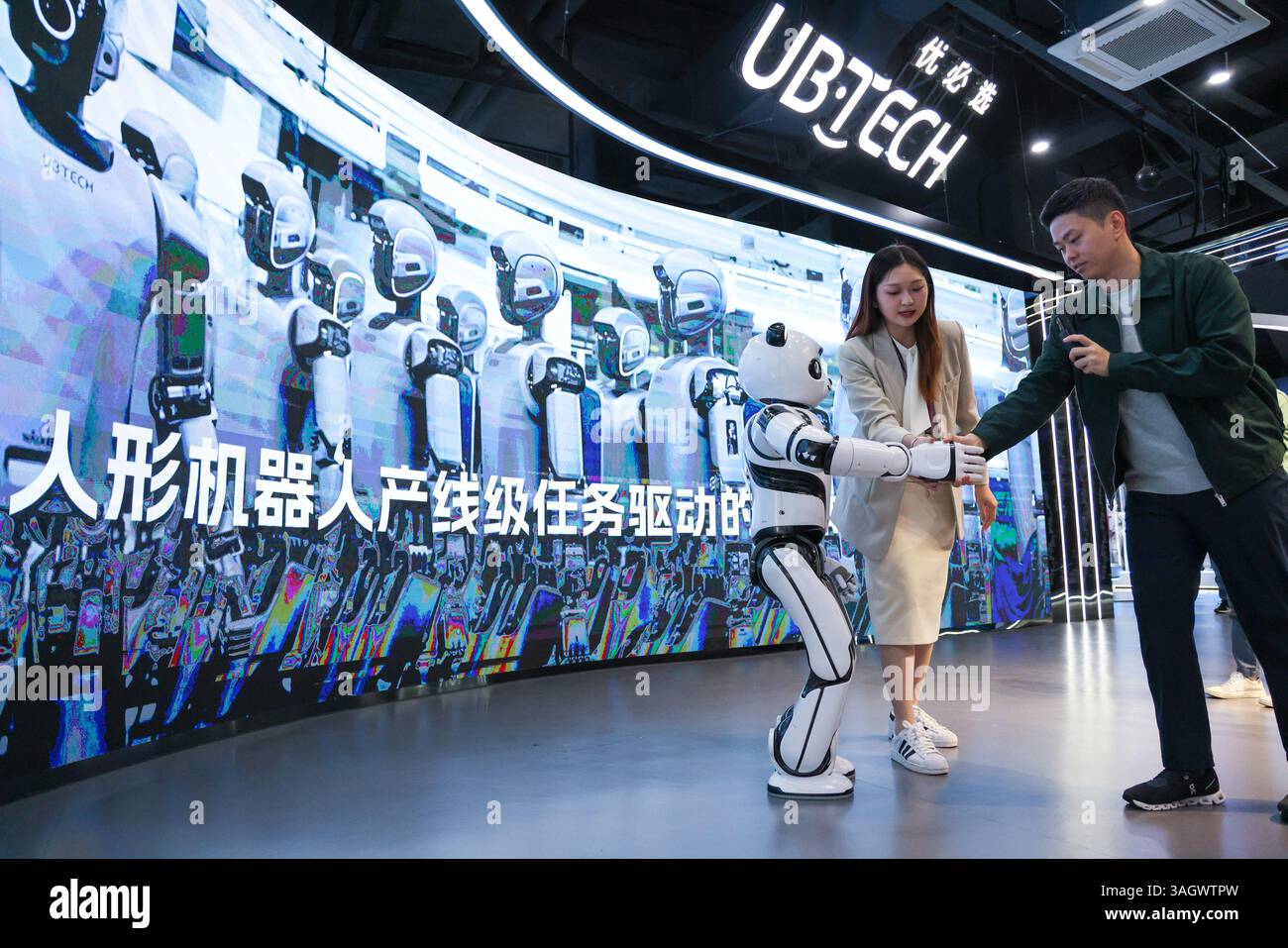 Shenzhen, China's Guangdong Province. 26th Mar, 2025. A robot shakes hands with a visitor at the ...