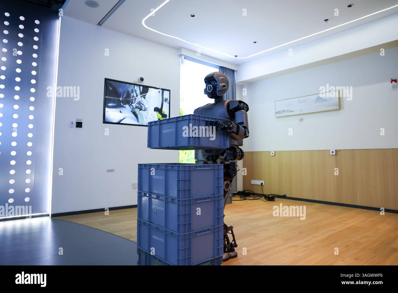 Shenzhen, China's Guangdong Province. 26th Mar, 2025. Humanoid robot Walker S1 carries a box at ...