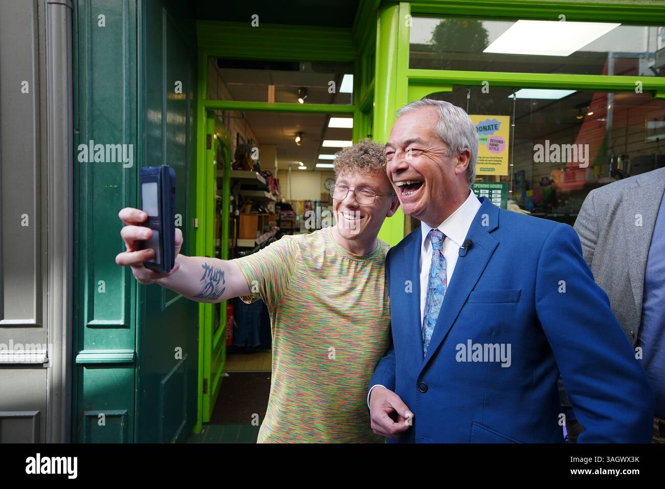 Reform UK leader Nigel Farage poses for a selfie during a walkabout in ...