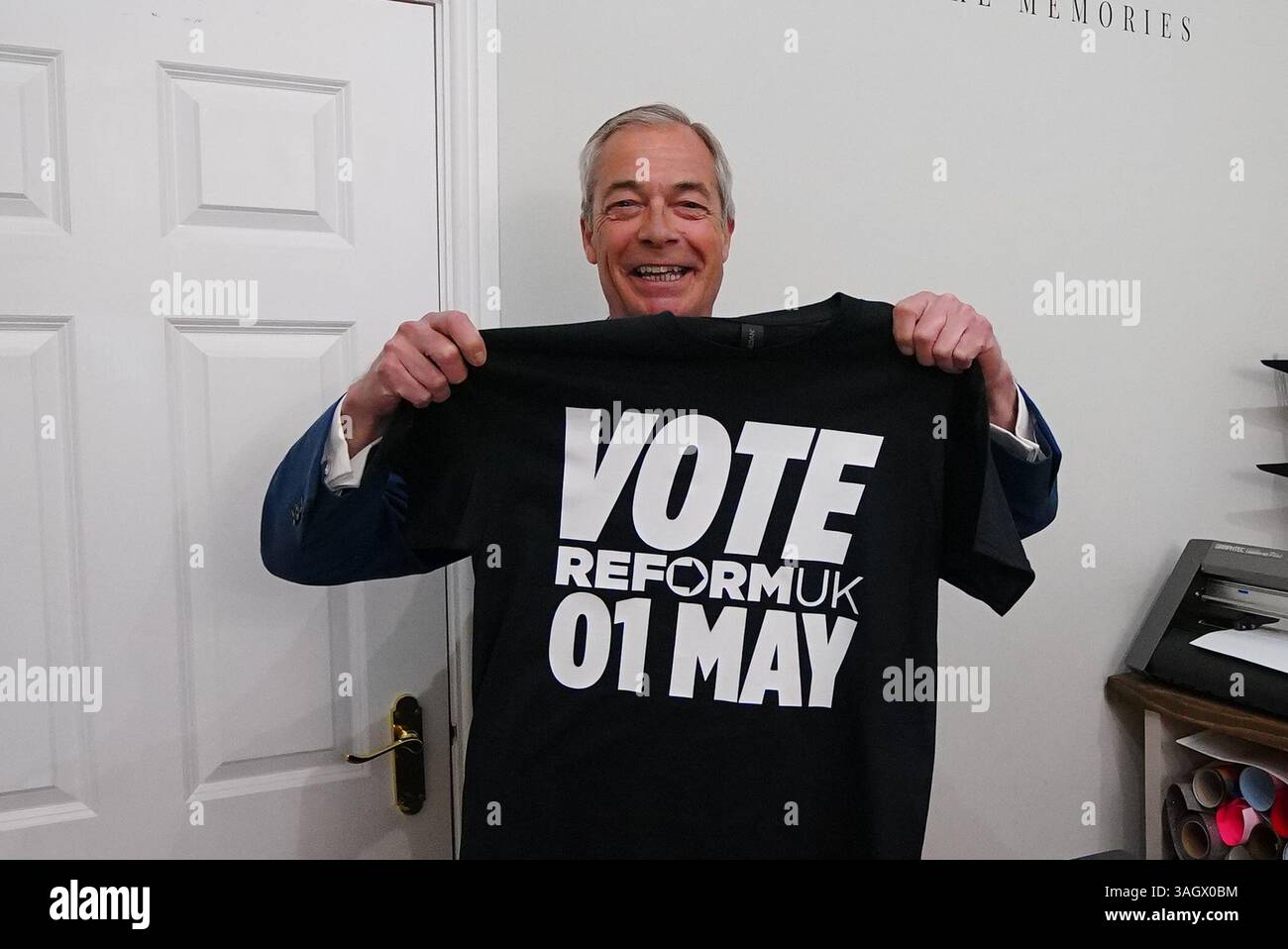 Reform UK leader Nigel Farage poses with the T-shirt he printed in a ...