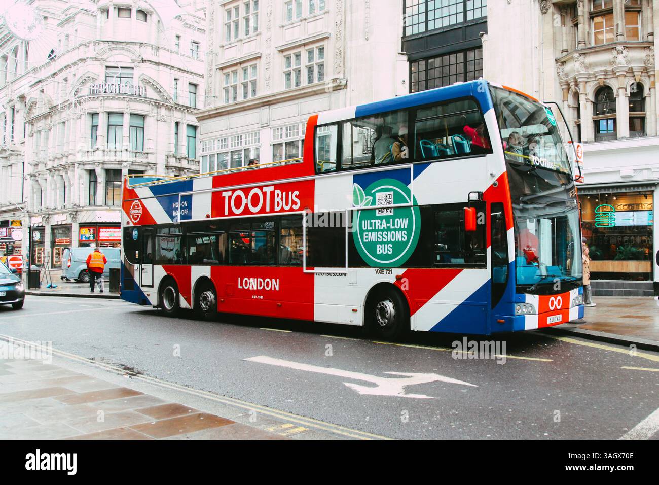 London open top TOOTBus for tourists visiting open air bus UK flag ...