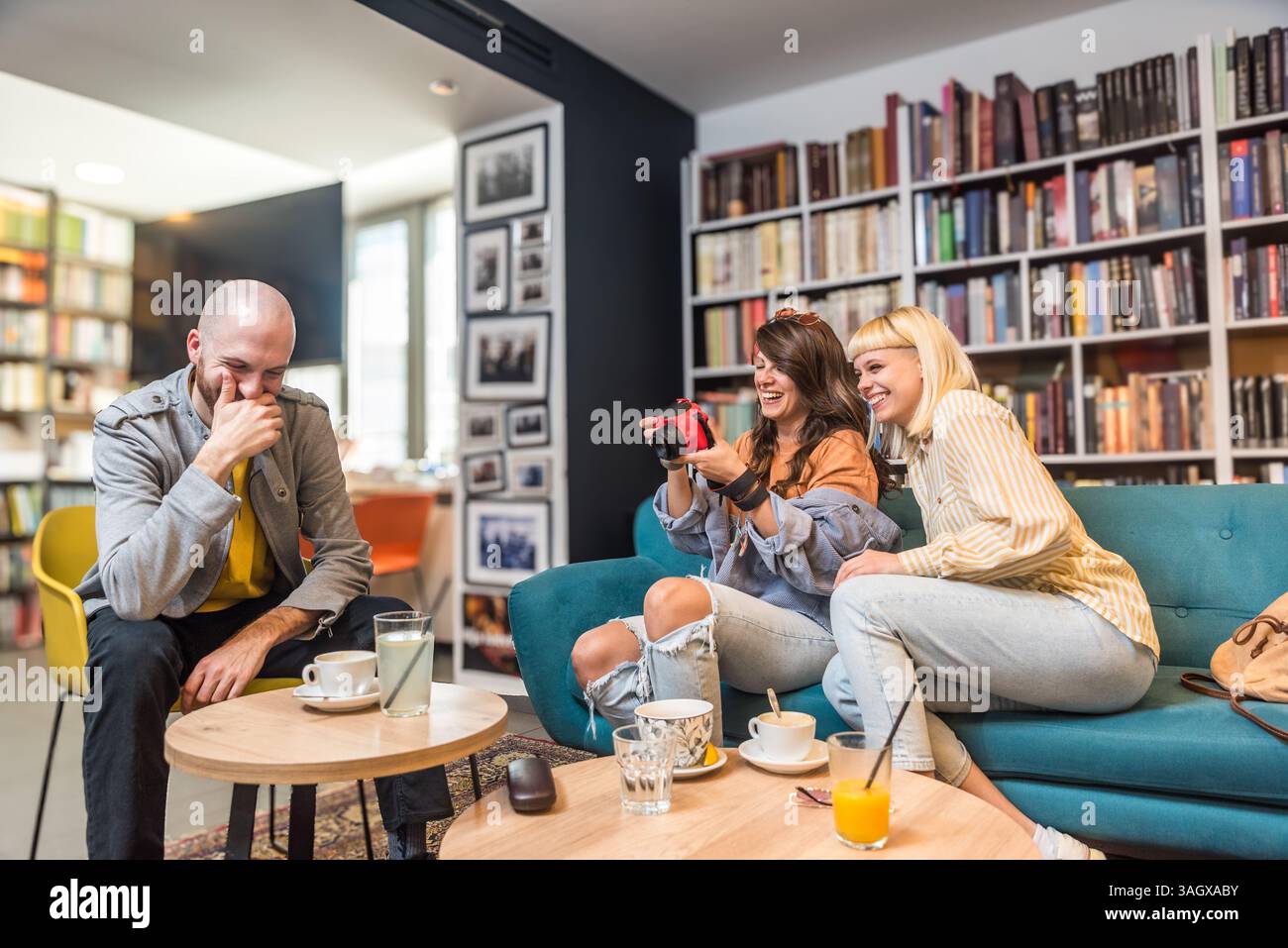 Happy young university students studying with books in library. Group ...