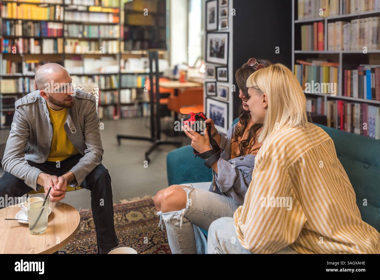 Happy young university students studying with books in library. Group ...